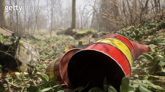 A dump in a green forest from poisonous barrels with chemicals that ...