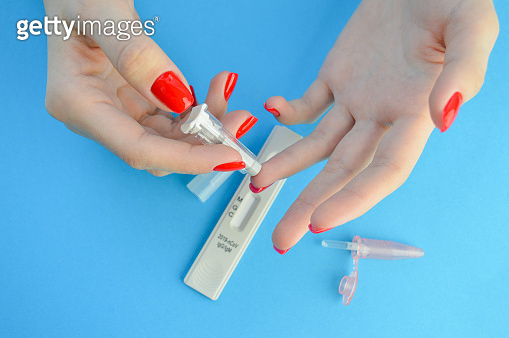 puncture of the finger with a lancet. quick blood test. test strip for ...