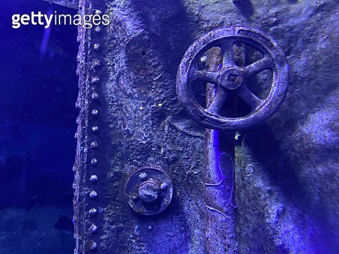 closed rusty submarine door with a valve, old vintage interior ...