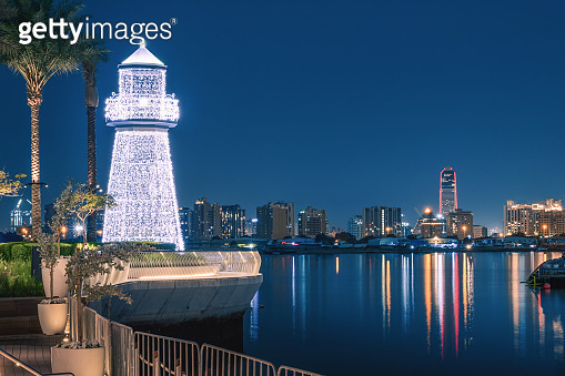 Illuminated decorative lighthouse near the parking lot of yachts and ...