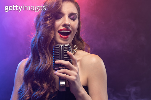 Cropped portrait of beautiful female jazz singer isolated over gradient ...