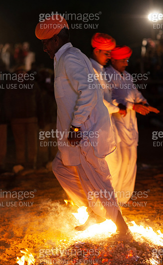 Indian fakir, fire eater dancing on coals during Camel festival, India ...