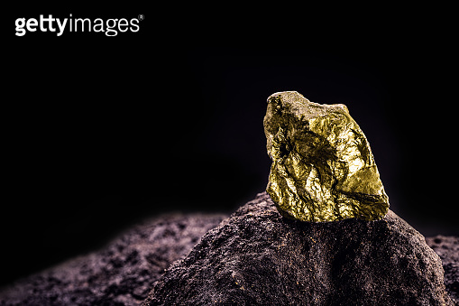 gold nugget on stone, gold inside cave, concept of rarity and luxury ...