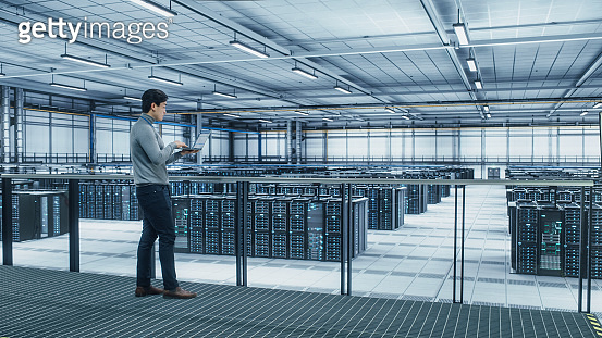 Data Center Engineer Using Laptop Computer. Server Farm Cloud Computing ...