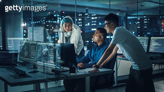 Diverse Team of Professionals Meeting in Office at Night: Brainstorming ...