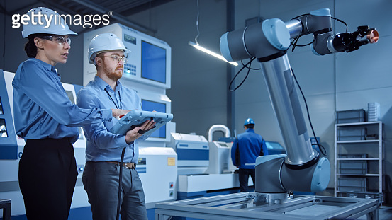 Factory Workshop: Professional Female Engineer, Male Machinery Operator ...