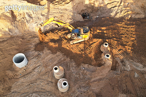 Excavator dig ground for sewerge construction. Trench for laying a ...
