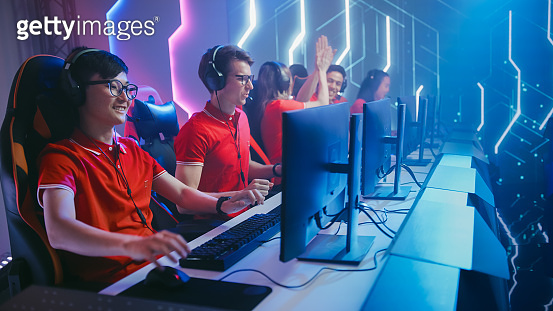 Two Esport Teams of Pro Gamers Play in Mock-up FPS Video Game on a ...
