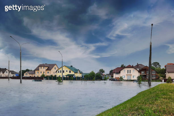 Extreme heavy rain storm weather. Flooded streets of the neighborhood ...