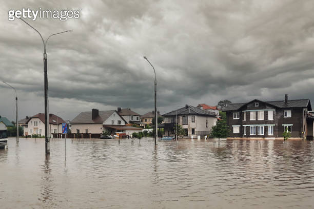 Extreme heavy rain storm weather. Flooded streets of the neighborhood ...