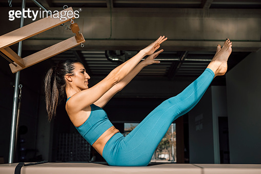 Pilates woman in reformer doing teaser exercise at gym (1306517266 ...
