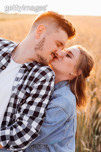 Young happy couple gives each other love and happiness during walk in ...