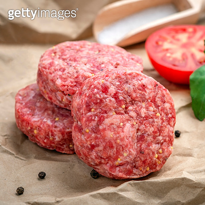 Homemade raw ground beef and Burger Patty with Basil, tomatoes and ...