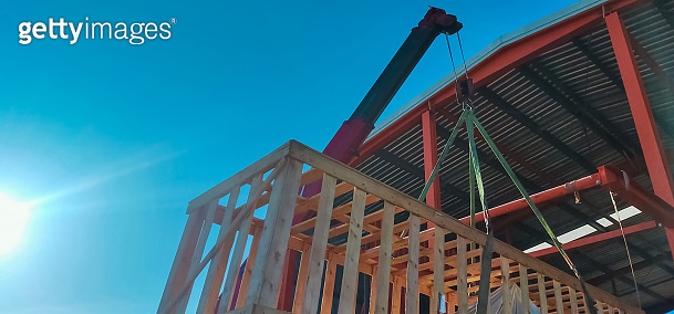 Boom truck crane lifting the machinery which storage in wooden box to ...
