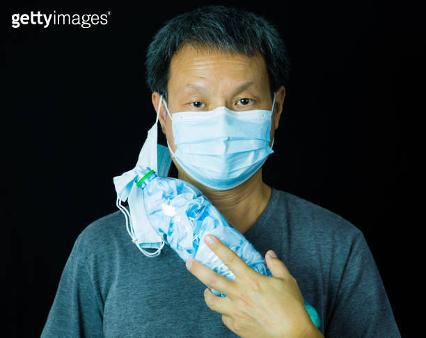 Thai man wear surgical mask with used masks in the bottle 이미지 ...