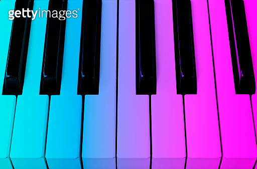 Top view of piano keys in blue and pink tones . Close-up of piano keys ...