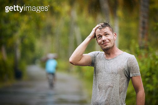 Man enjoying heavy rain in nature 이미지 (1360388258) - 게티이미지뱅크