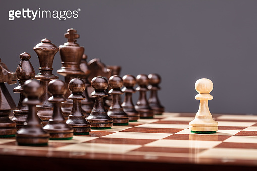 Beige Pawn Standing Against Set Of Chess 이미지 (1322052253) - 게티이미지뱅크