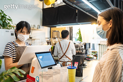 Asian customer girl ordering takeaway food with waiter worker at cafe ...