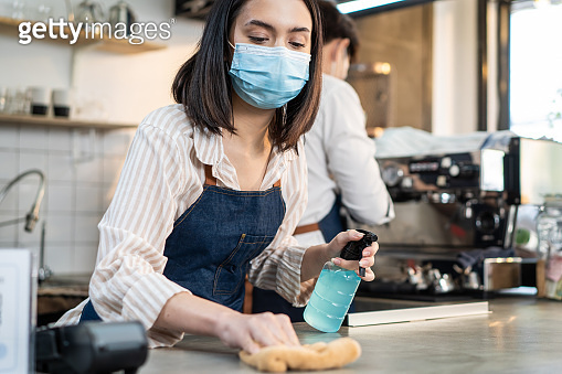 Cafe waiter wear mask, clean restaurant with sanitizer to open store ...
