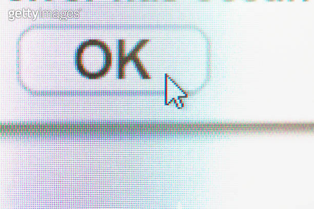 Close-up of OK button and mouse pointer on simulated computer interface ...