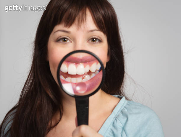 Beautiful young woman with her mouth and teeth bizarrely enlarged by a ...