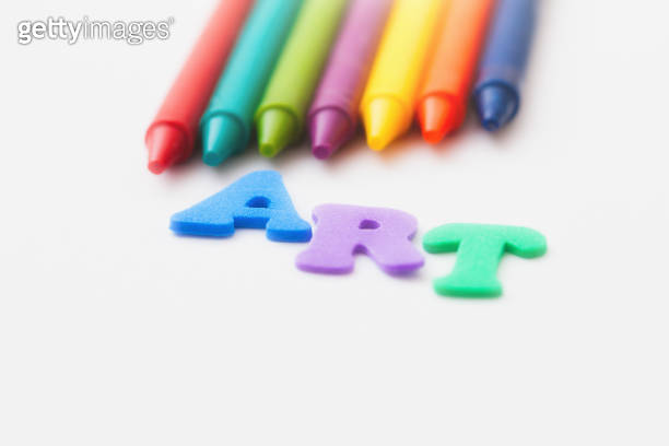 Foam plastic letters spell out the word ART in front of a row of ...