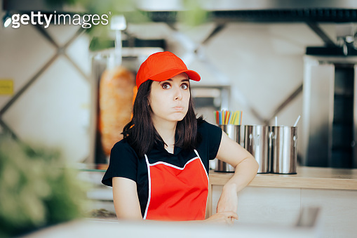Tired Female Fast Food Worker Resting on a Chair 이미지 (1328064131) - 게티이미지뱅크