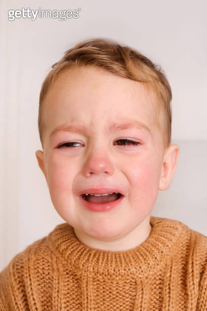 Sad little boy is crying. Toddler child has stress, pain and is tired ...