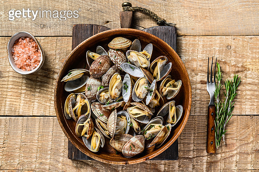 Steamed cooked shells Clams vongole in a wooden plate. wooden ...