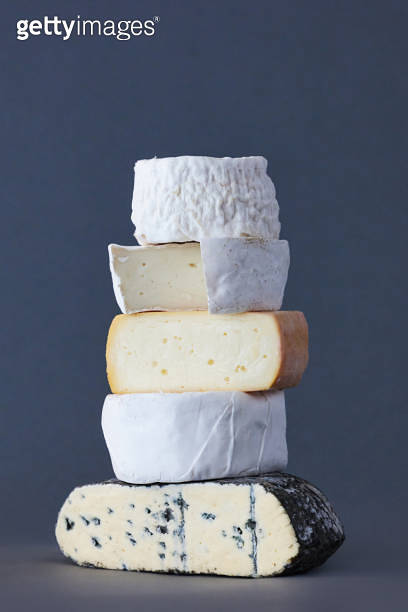 Stack Of Artisan Organic Cheese Against Grey Background 이미지 (1306120046 ...