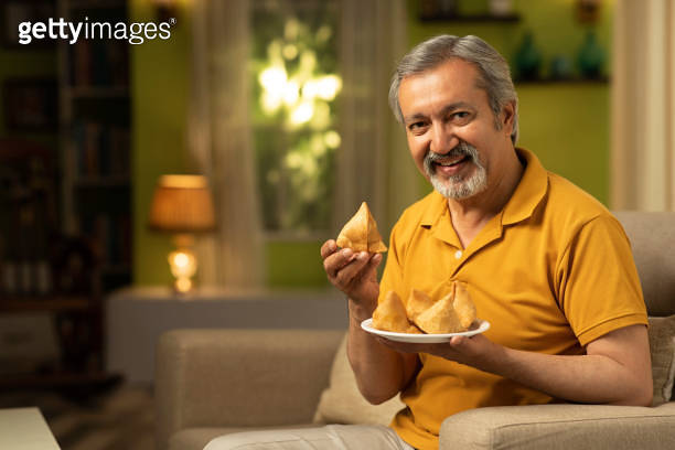 shot of a mature man eating samosa at home:-stock photo 이미지 (1306500788 ...