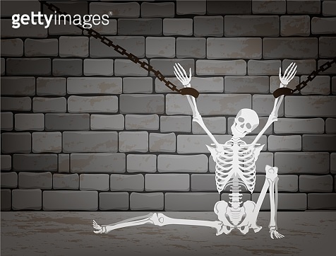 Skeleton chained in dungeon. Prisoner dying of hunger in terrible agony ...