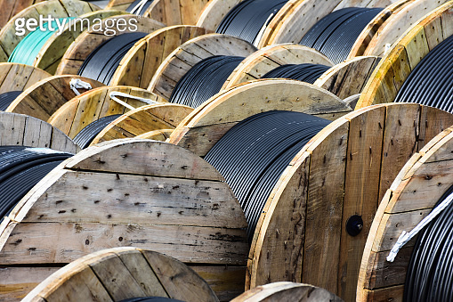 Wooden Coils Of Electric Cable Outdoor. High and low voltage cables in ...