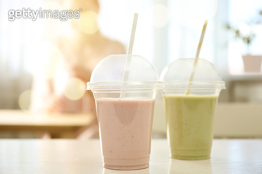 Tasty fresh milk shakes in plastic cups in cafe 이미지 (1357403638) - 게티이미지뱅크