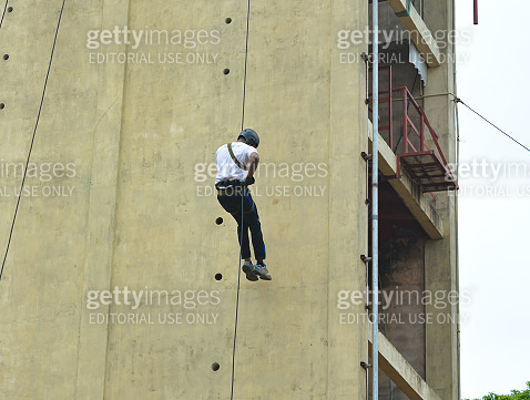Srilankan army Soldier practice rappelling on tower. Rope sliding ...