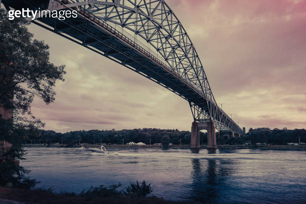 Rugged twilight seascape under Bourne Bridge at Cape Cod Canal with a ...