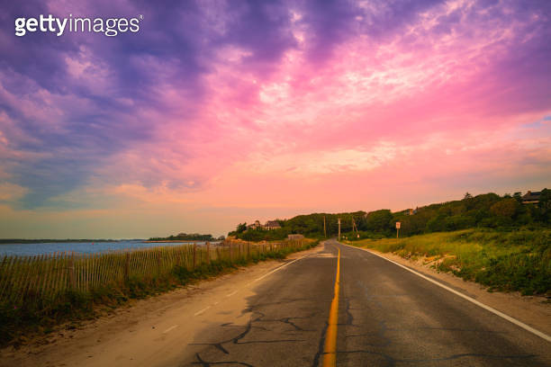 Pink sunrays and purple clouds in the dramatic sky after rain over the ...