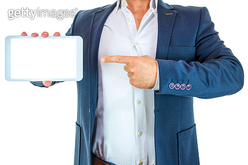 Man in suit pointing the tablet with the index finger while holding the ...