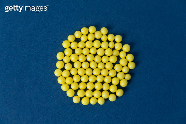 Small round yellow vitamins are arranged in a circle. 이미지 (1357402496 ...