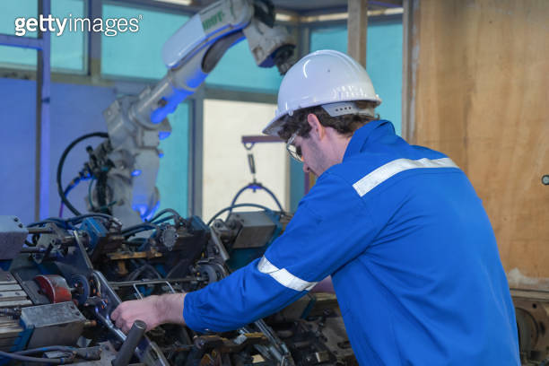 Industrial worker on quality control using steel measuring tape measure ...