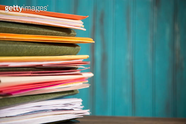 Stack of file folders with documents on a wooden top desk. 이미지 ...