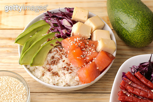 poke bowl Hawaiian food. a plate of rice, salmon, avocado, cabbage and ...