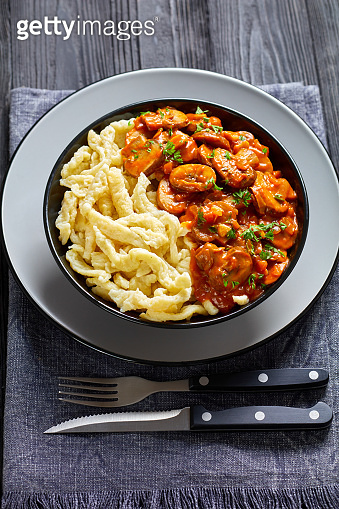 spaetzle with mushroom gravy in a black bowl, jagerspatzle ...