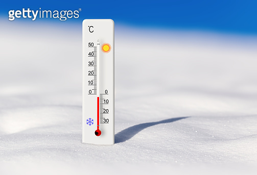 White celsius scale thermometer in the snow. Ambient temperature minus ...