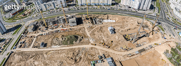 panoramic aerial view of large urban construction site with cranes and ...