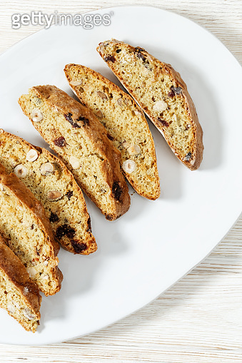 Several pieces Italian biscotti cookies on black baking sheet. Fresh ...