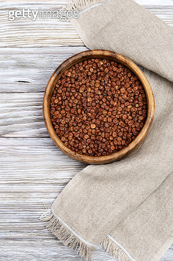 Raw gray peas in round wooden bowl on light wood. Organic healthy diet ...