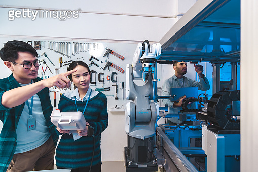 Team of engineers are conducting an experiment with robots.Close Up of ...
