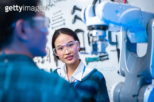 Team of engineers are conducting an experiment with robots.Close Up of ...
